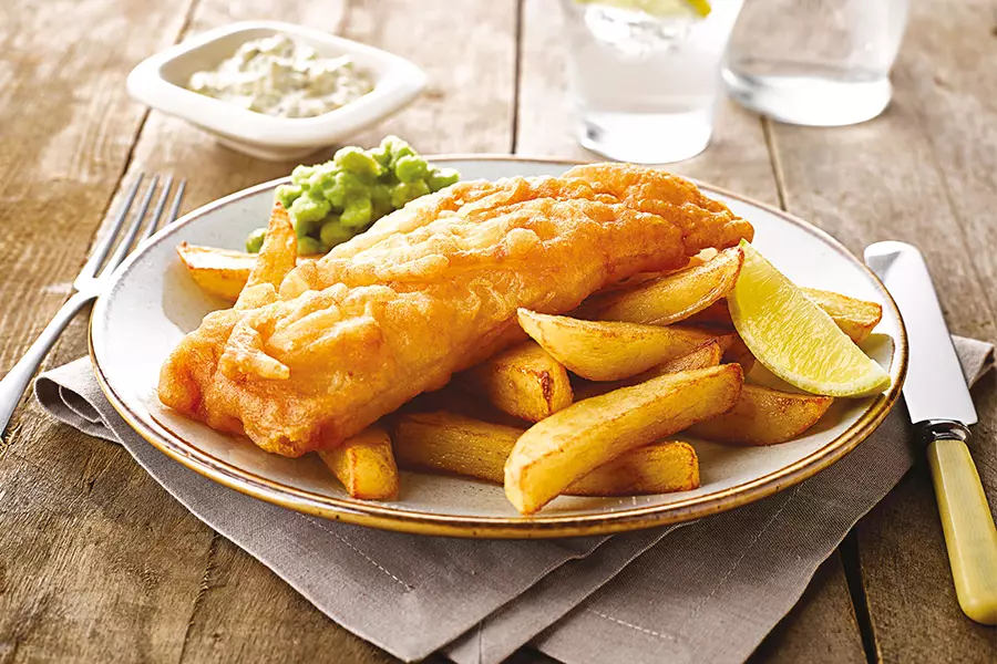 What is the origin of the traditional dish "fish and chips" in England?